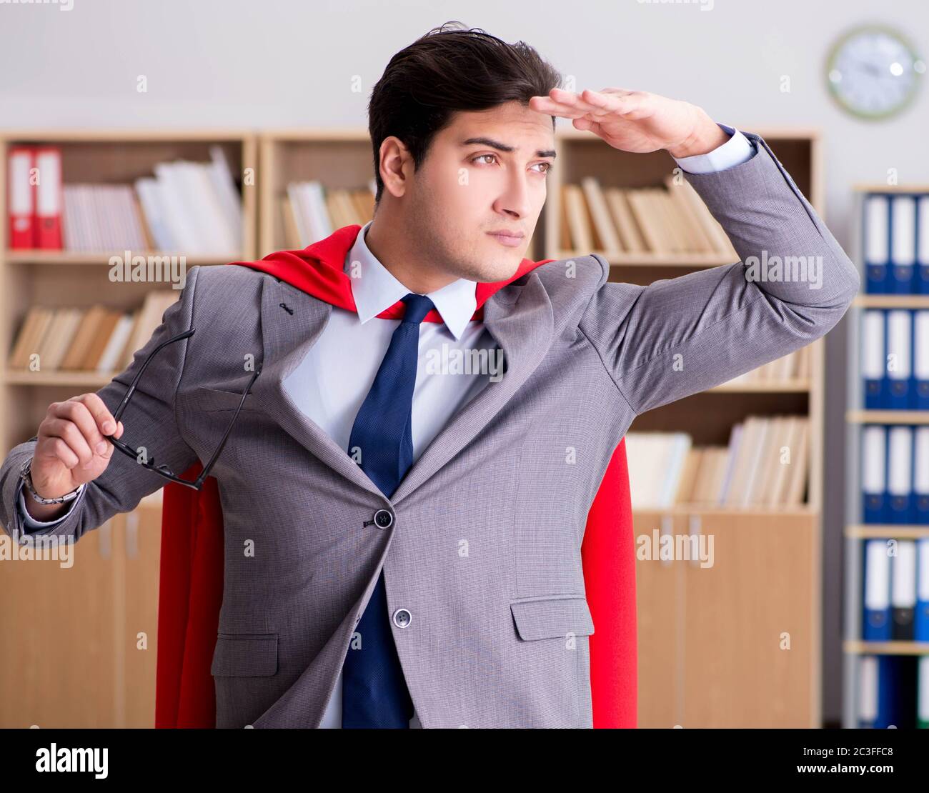 Superhero businessman working in the office Stock Photo - Alamy