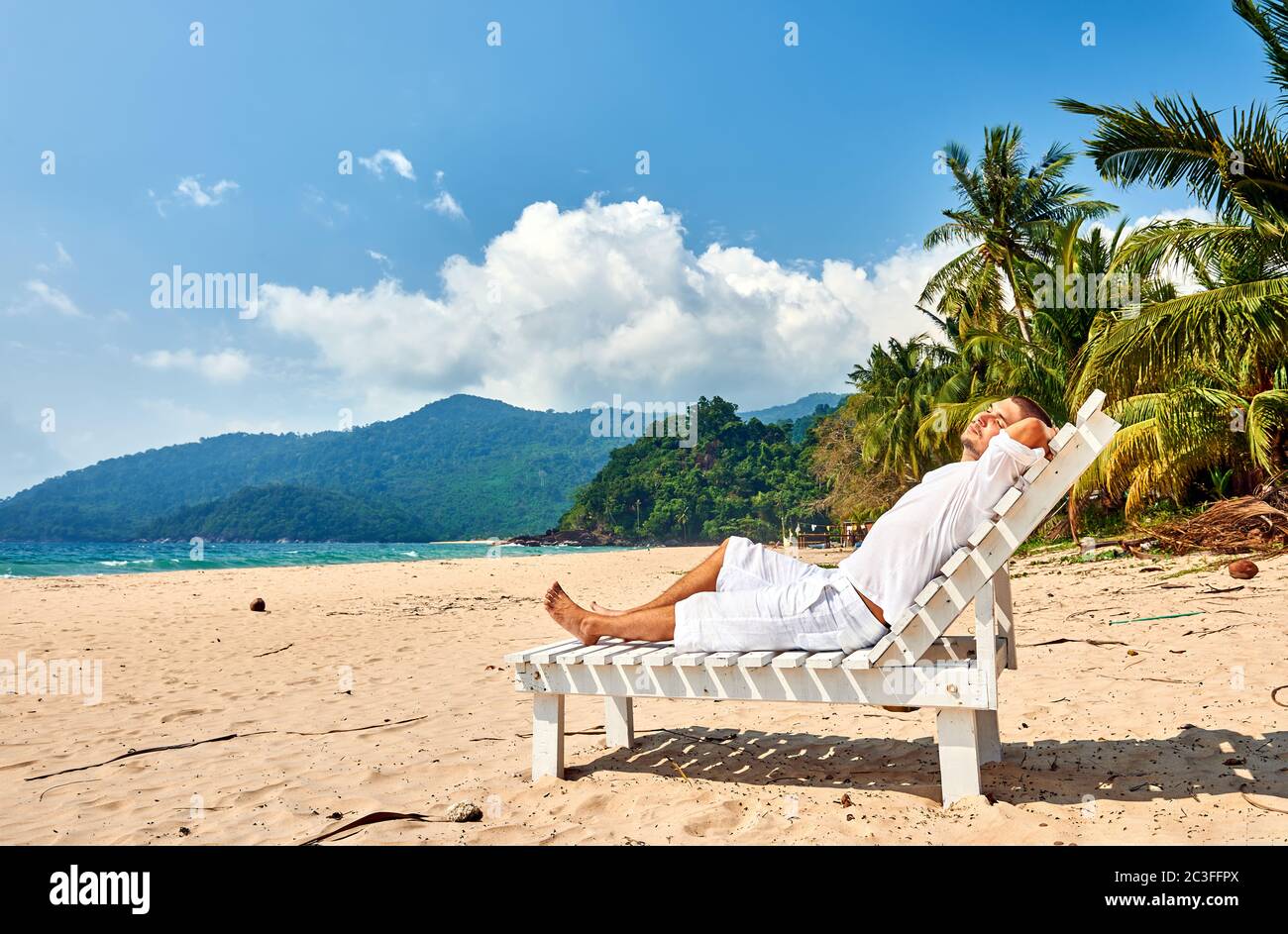 Man relaxing on beach bed hi-res stock photography and images - Alamy