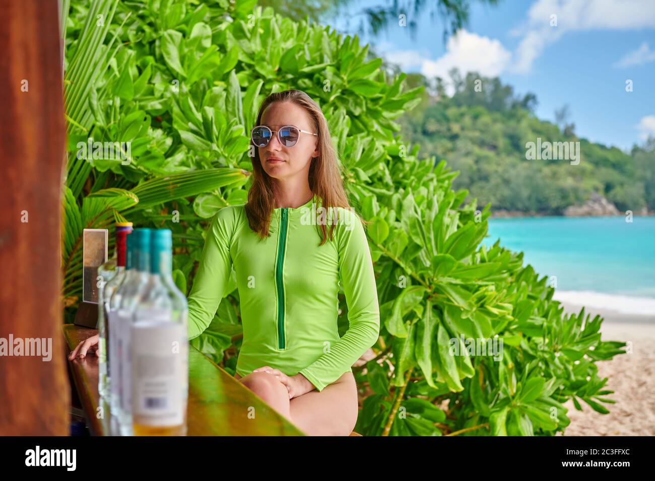 Woman in swimsuit at beach bar. Seychelles, Mahe Stock Photo - Alamy