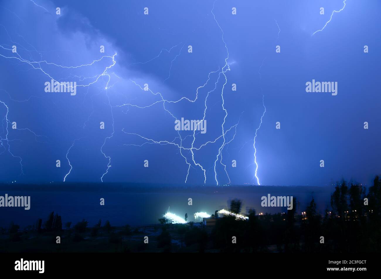 Bright night flash of lightning over the river Stock Photo - Alamy