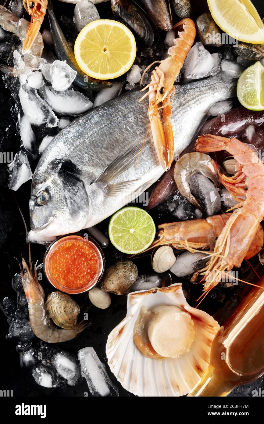 Fish and seafood. Sea bream with scallops, caviar, shrimps and lemons ...