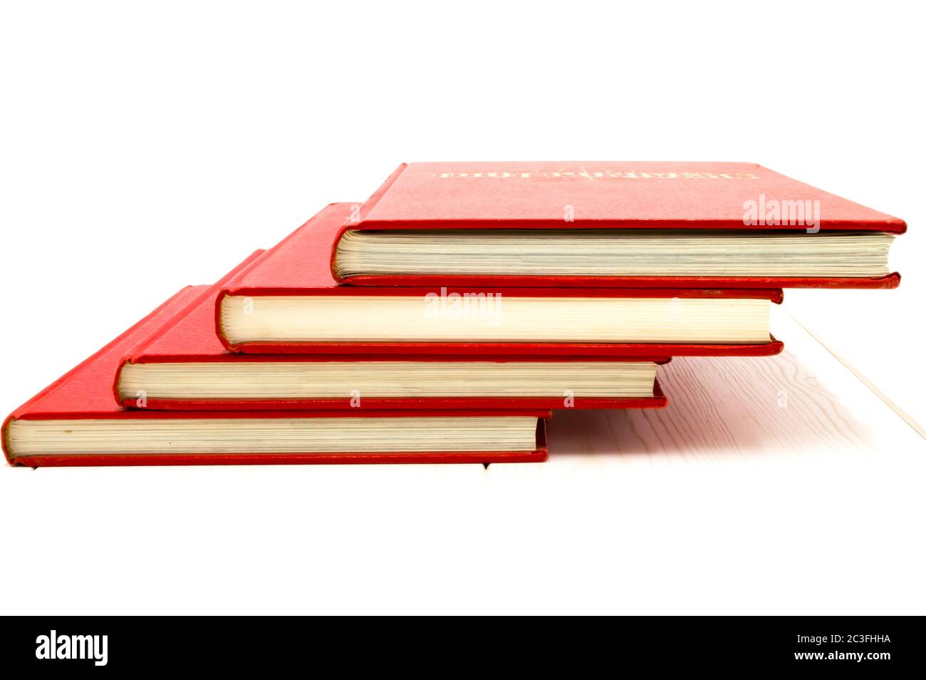 Red books flip over on a floor with white background Stock Photo - Alamy
