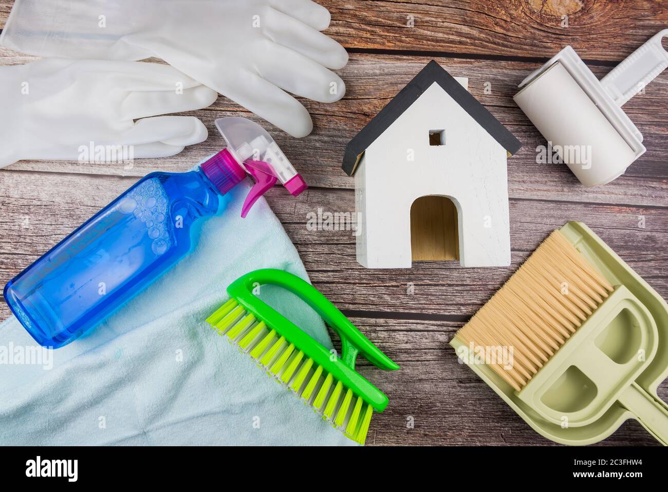 Wooden model white houses and house cleaning equipment on a teble ...