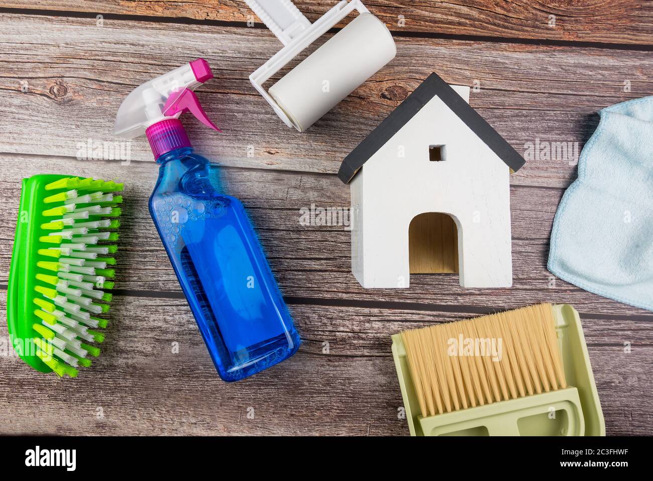 Wooden model white houses and house cleaning equipment on a teble ...