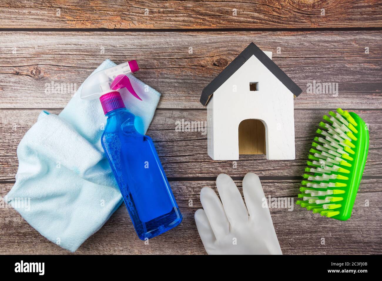 Wooden model white houses and house cleaning equipment on a teble ...