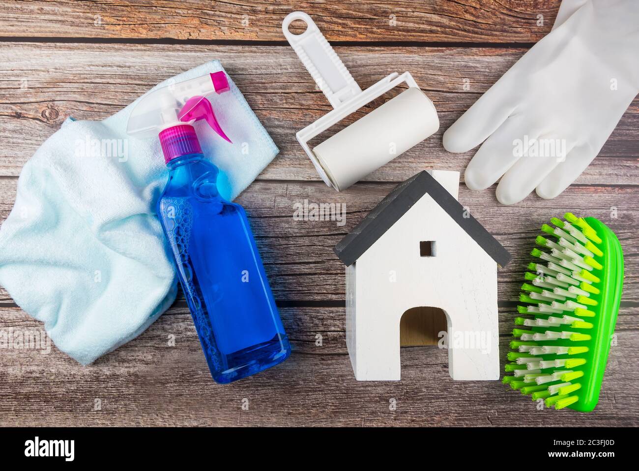 Wooden model white houses and house cleaning equipment on a teble ...