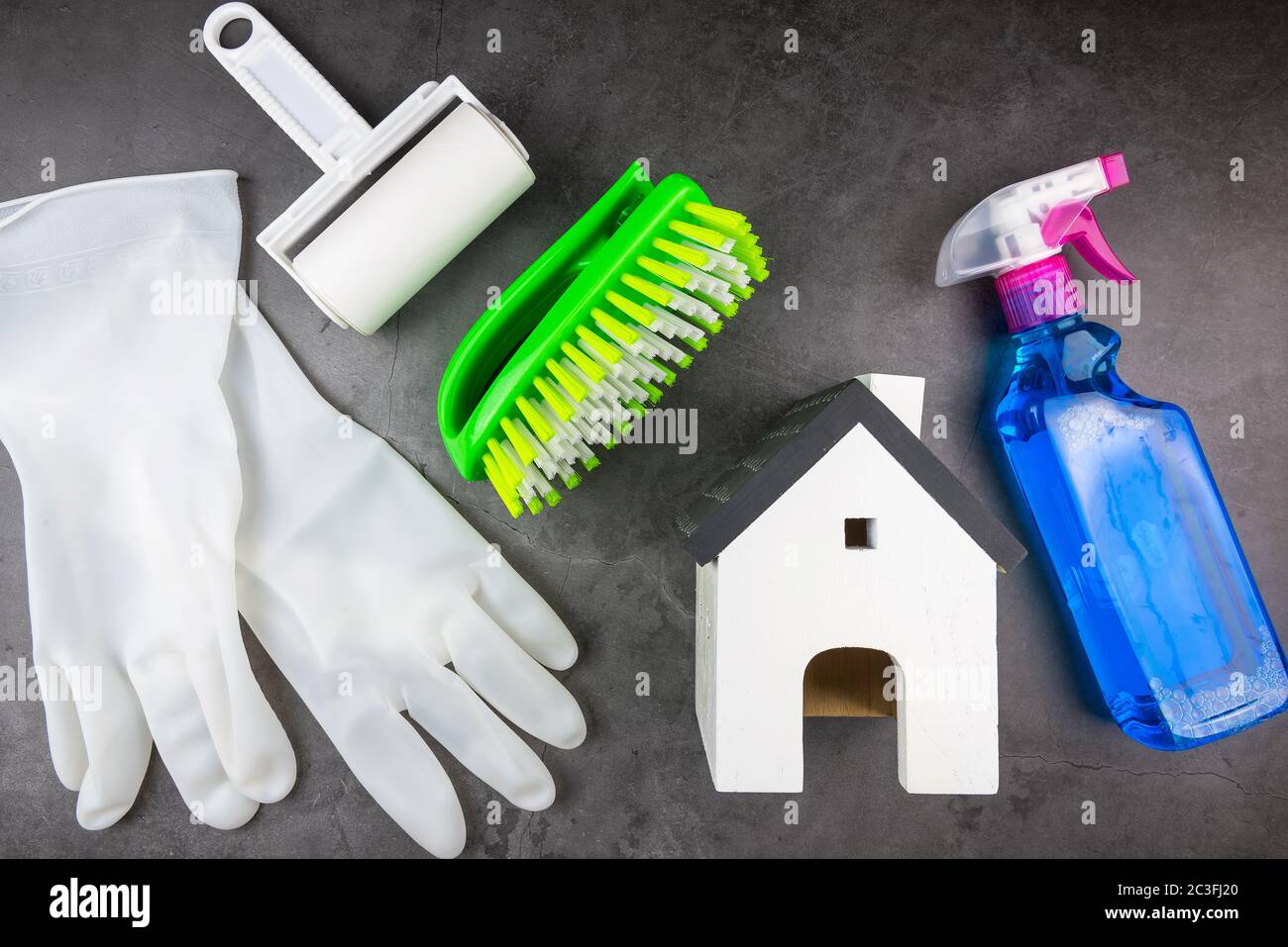 Wooden model white houses and house cleaning equipment on cement gray ...