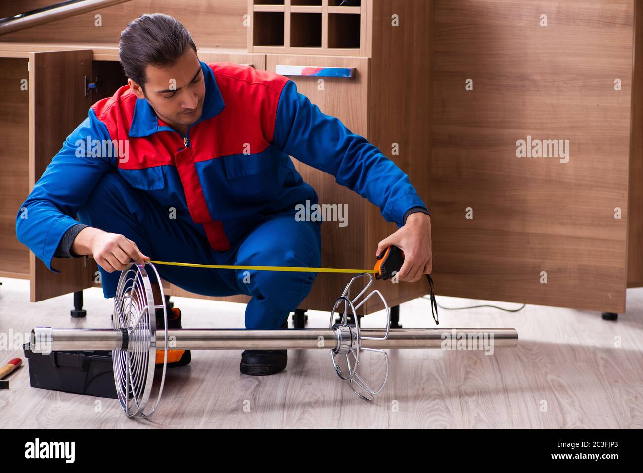 Handsome young carpenter measuring hi-res stock photography and images ...