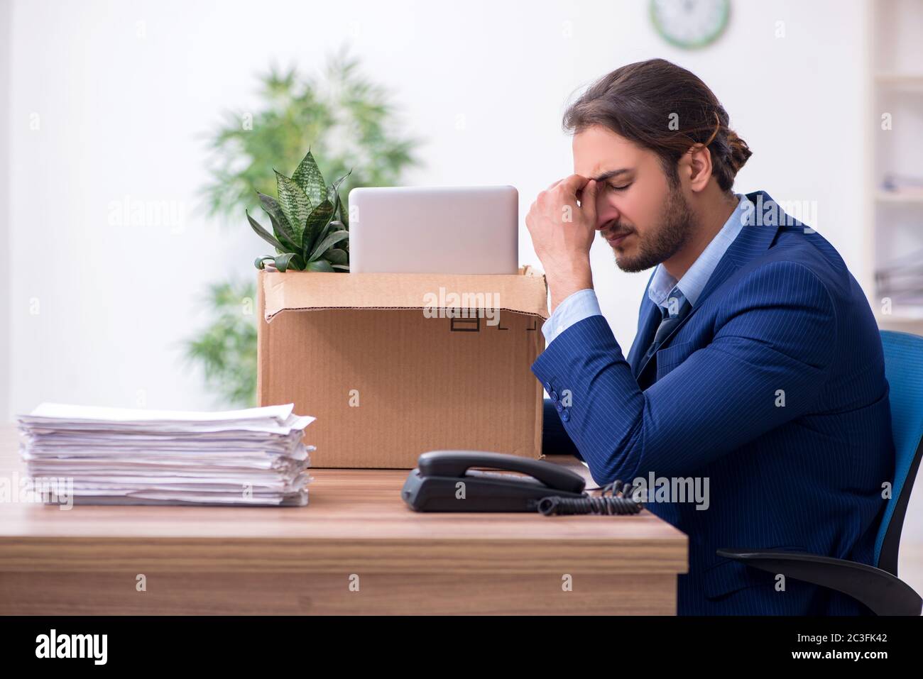 Young man being fired from his work Stock Photo - Alamy