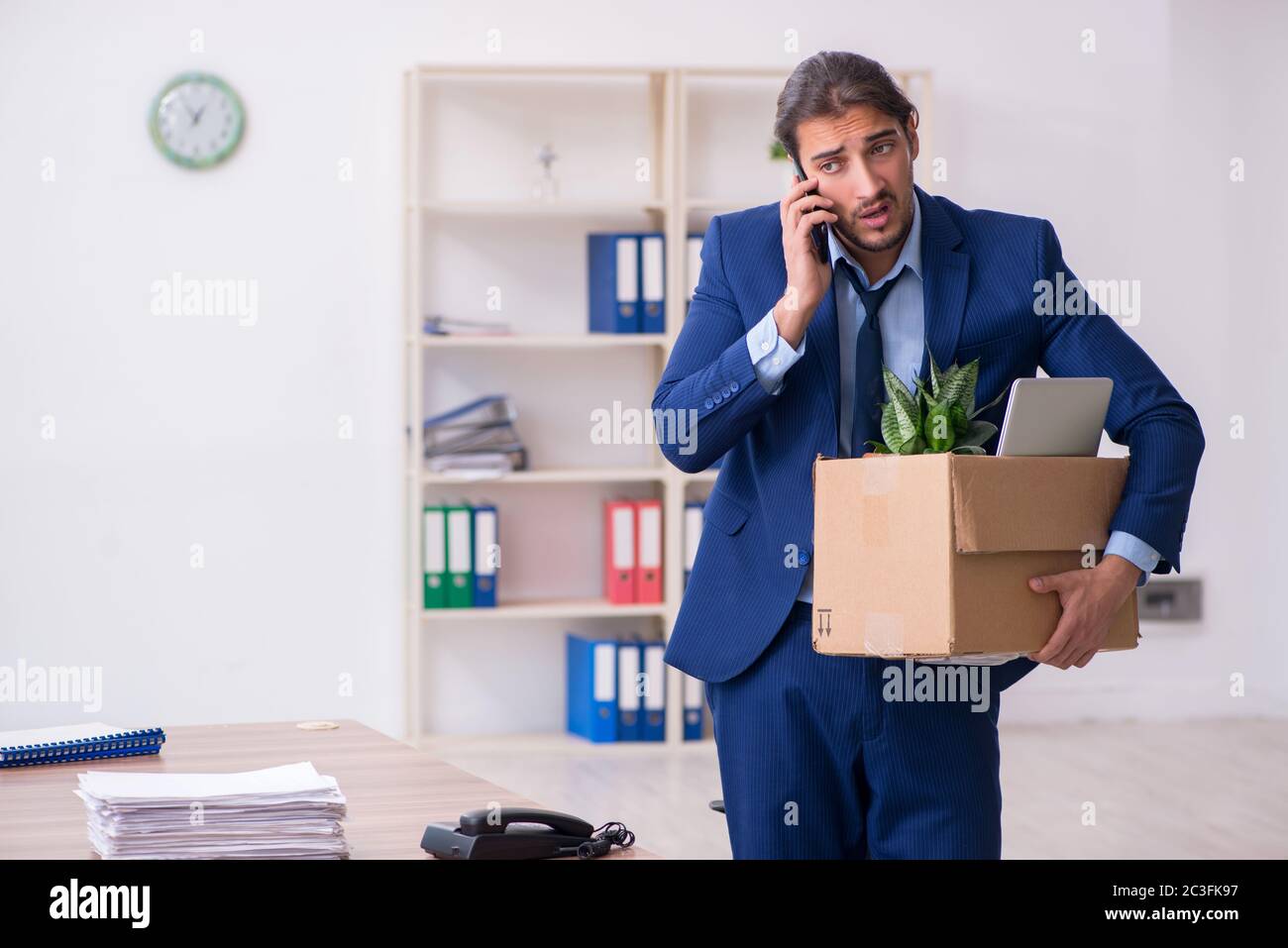 Young man being fired from his work Stock Photo - Alamy