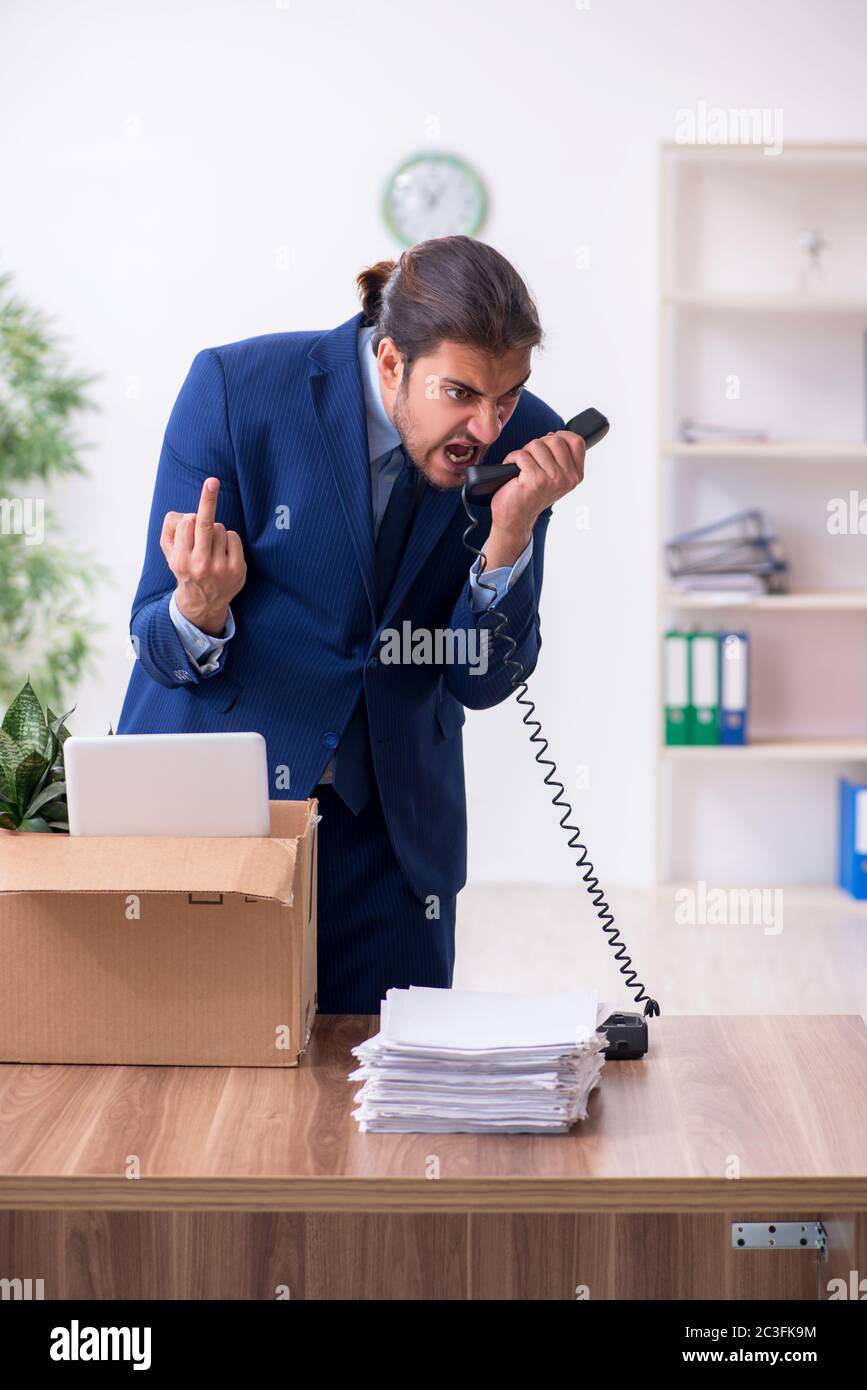 Young man being fired from his work Stock Photo - Alamy