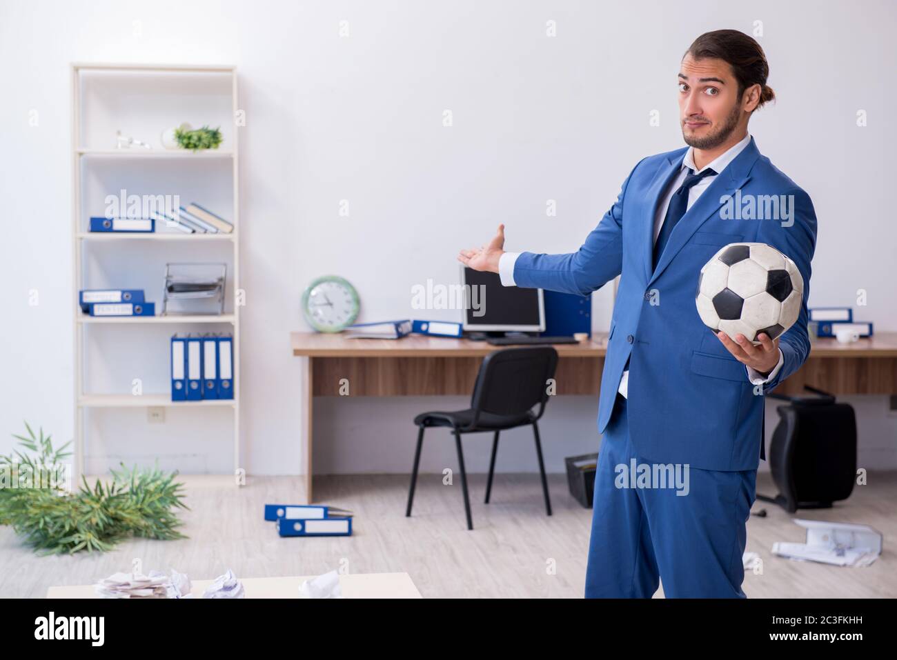 Man in suit kicking football hi-res stock photography and images - Alamy
