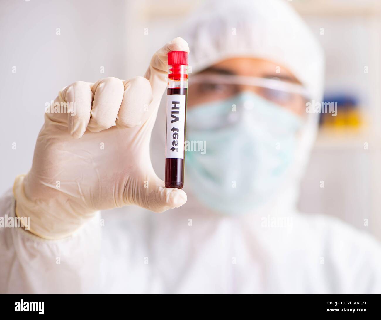 Young handsome lab assistant testing blood samples in hospital Stock ...