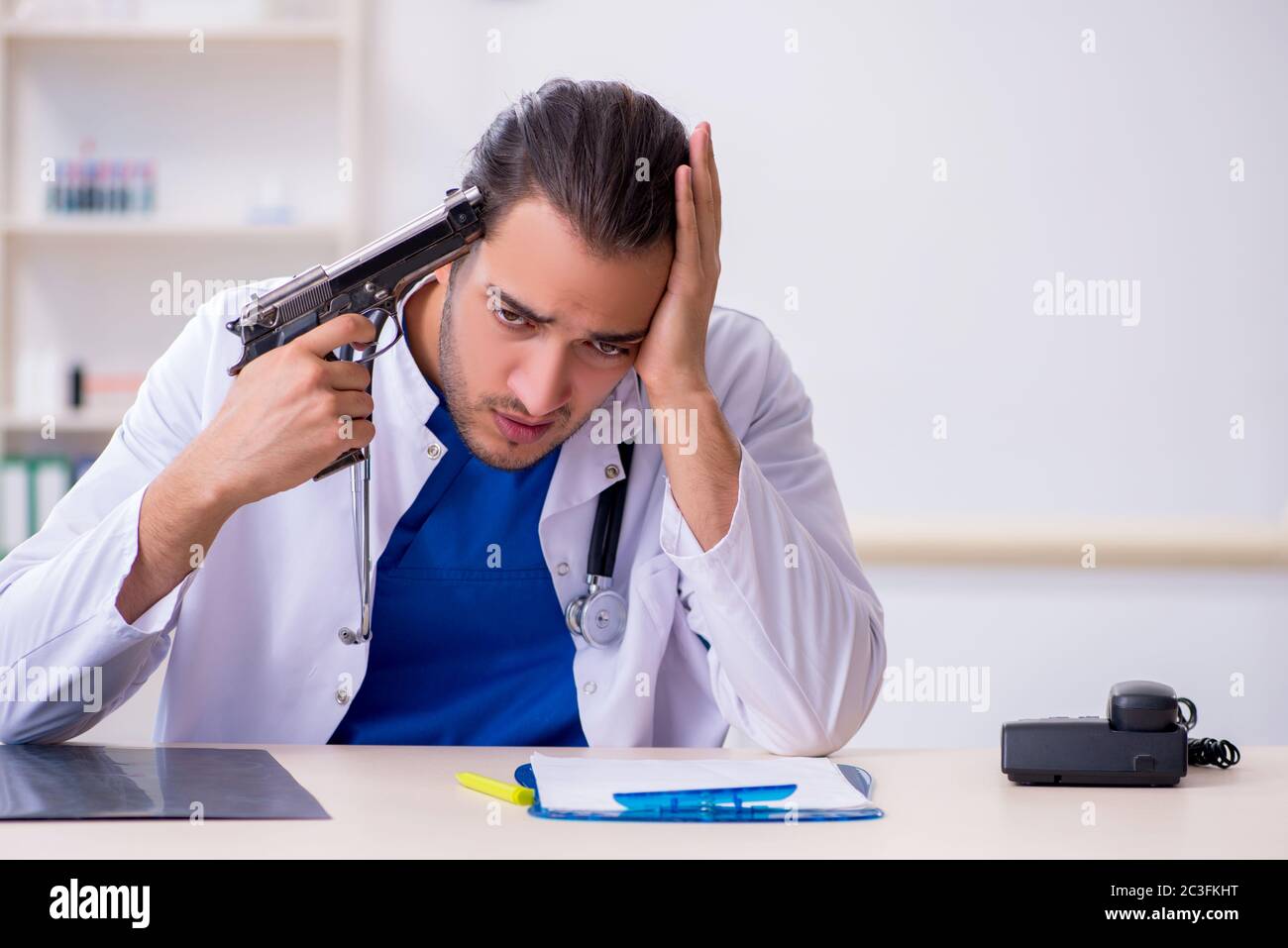 Young male doctor being tired after night shift Stock Photo - Alamy