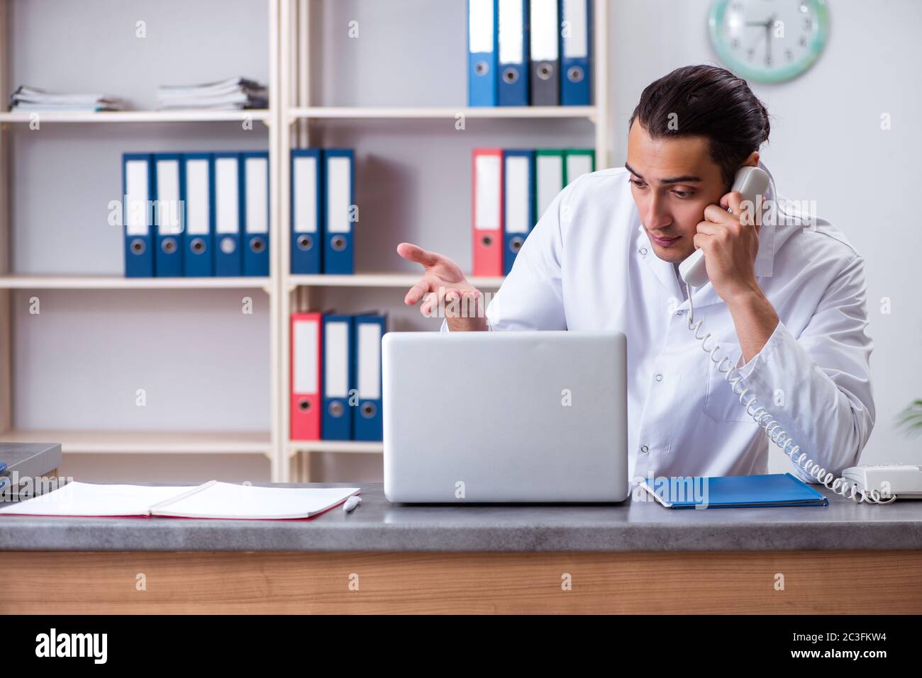 Young male doctor at the reception in the hospital Stock Photo - Alamy