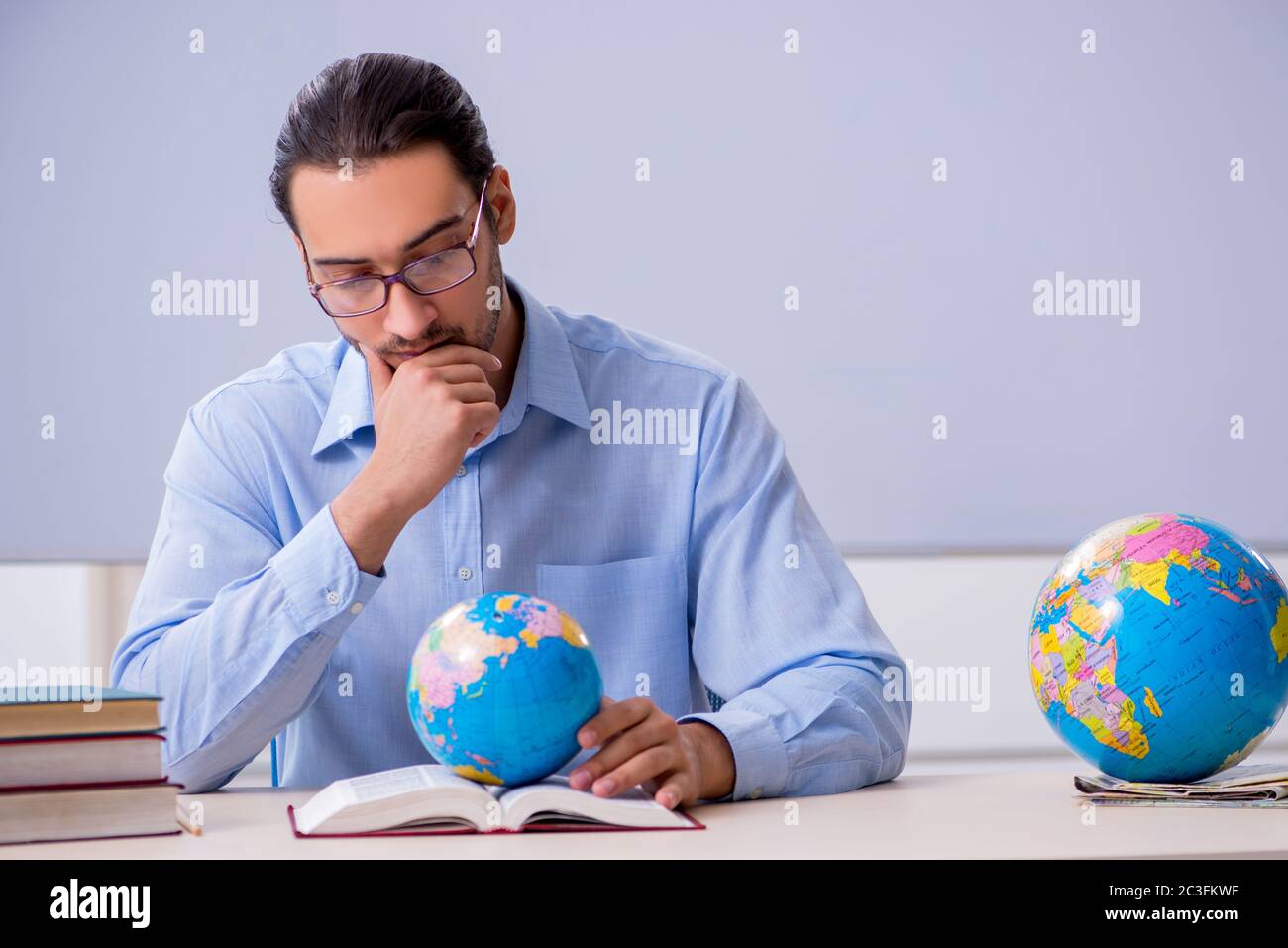 Young geography teacher explaining lesson hi-res stock photography and ...