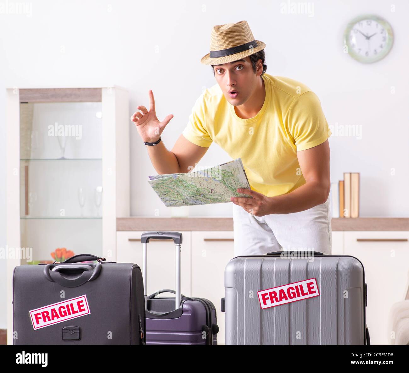 Man going on vacation with fragile suitcases Stock Photo - Alamy