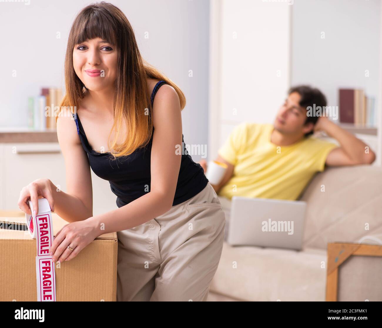 Young pair moving to new flat with fragile things Stock Photo - Alamy