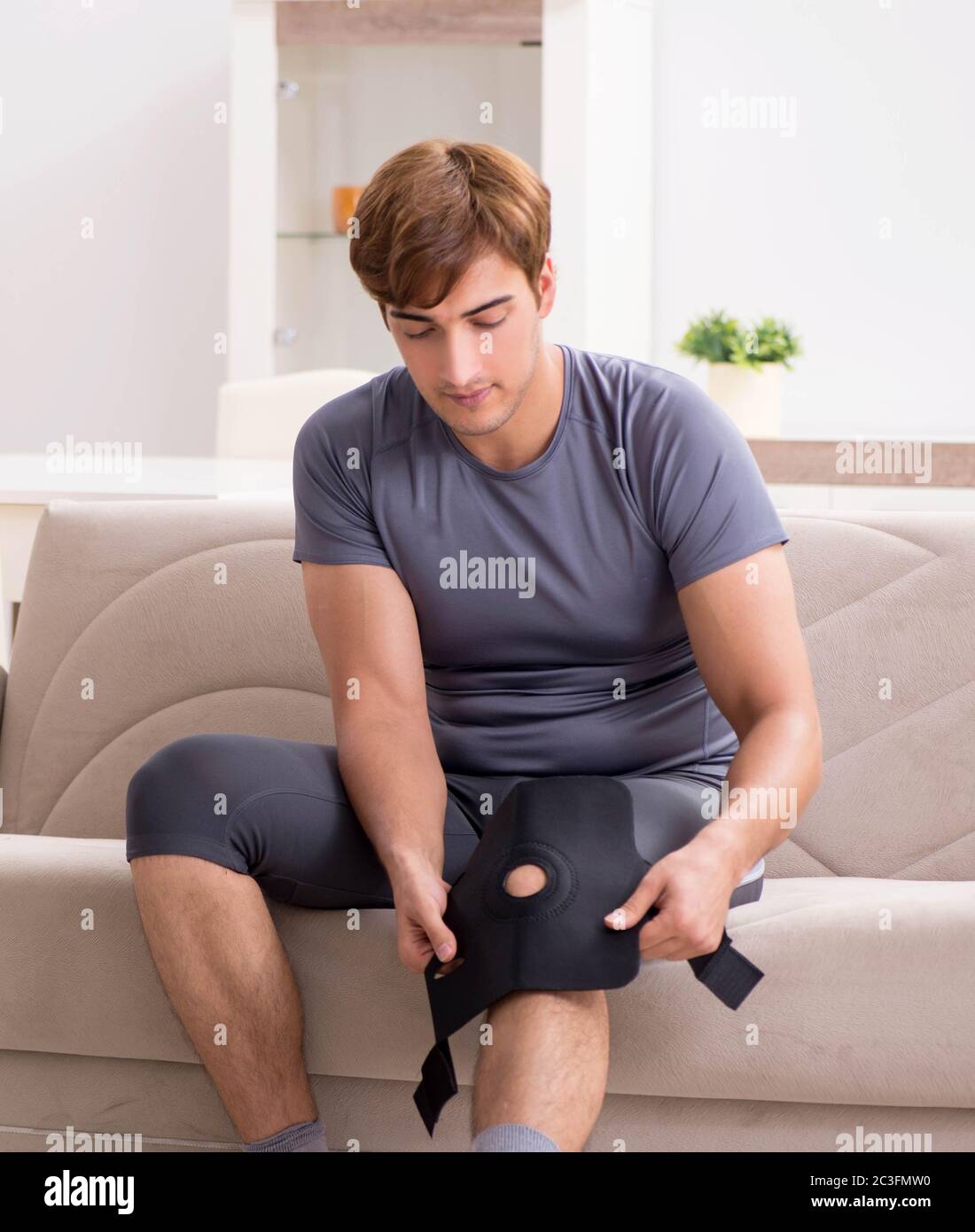 Injured man recovering at home from sports injury Stock Photo - Alamy