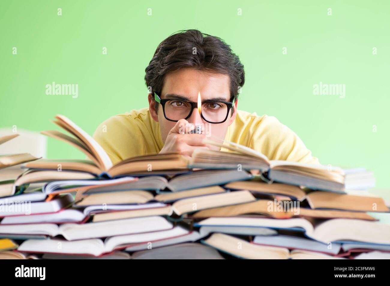Student with too many books to read before exam Stock Photo - Alamy