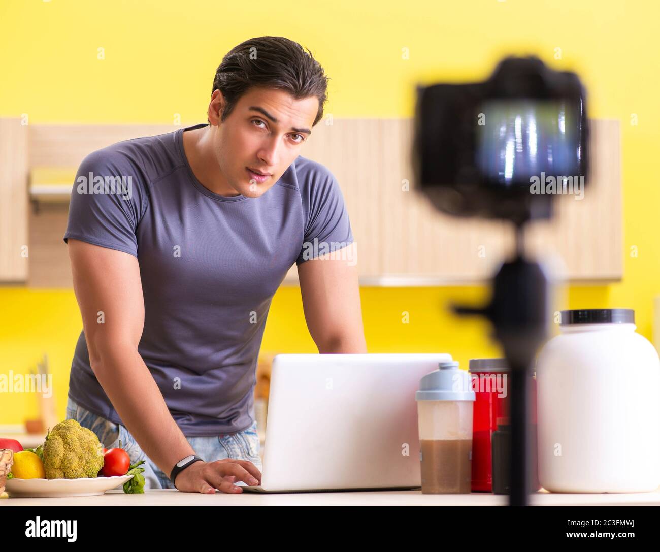 Young man blogging about food supplements Stock Photo - Alamy