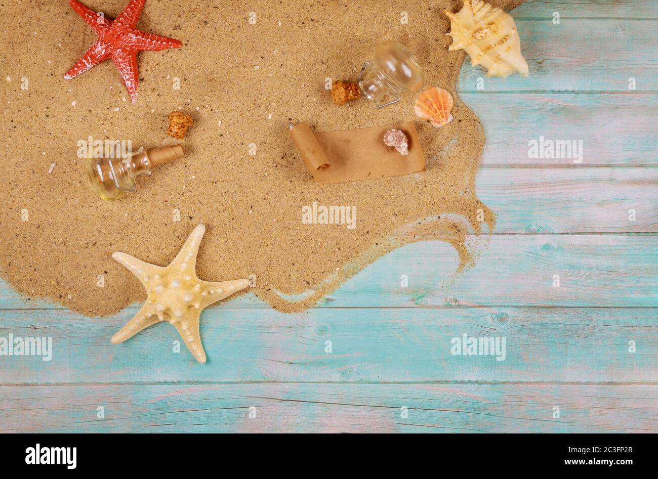Vacation concept background with sand, shells and starfish on blue wood ...