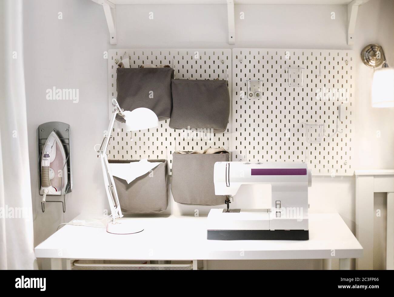 Sewing machine on table in tailor workshop Stock Photo - Alamy