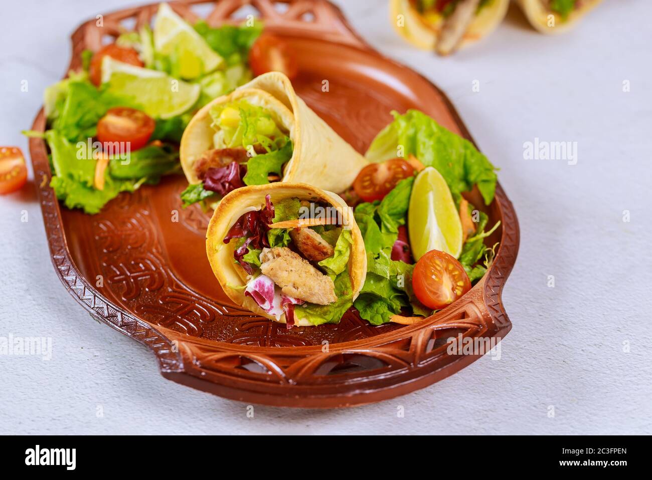 Latin style food tortilla baked cones with meat and salad on brown tray ...