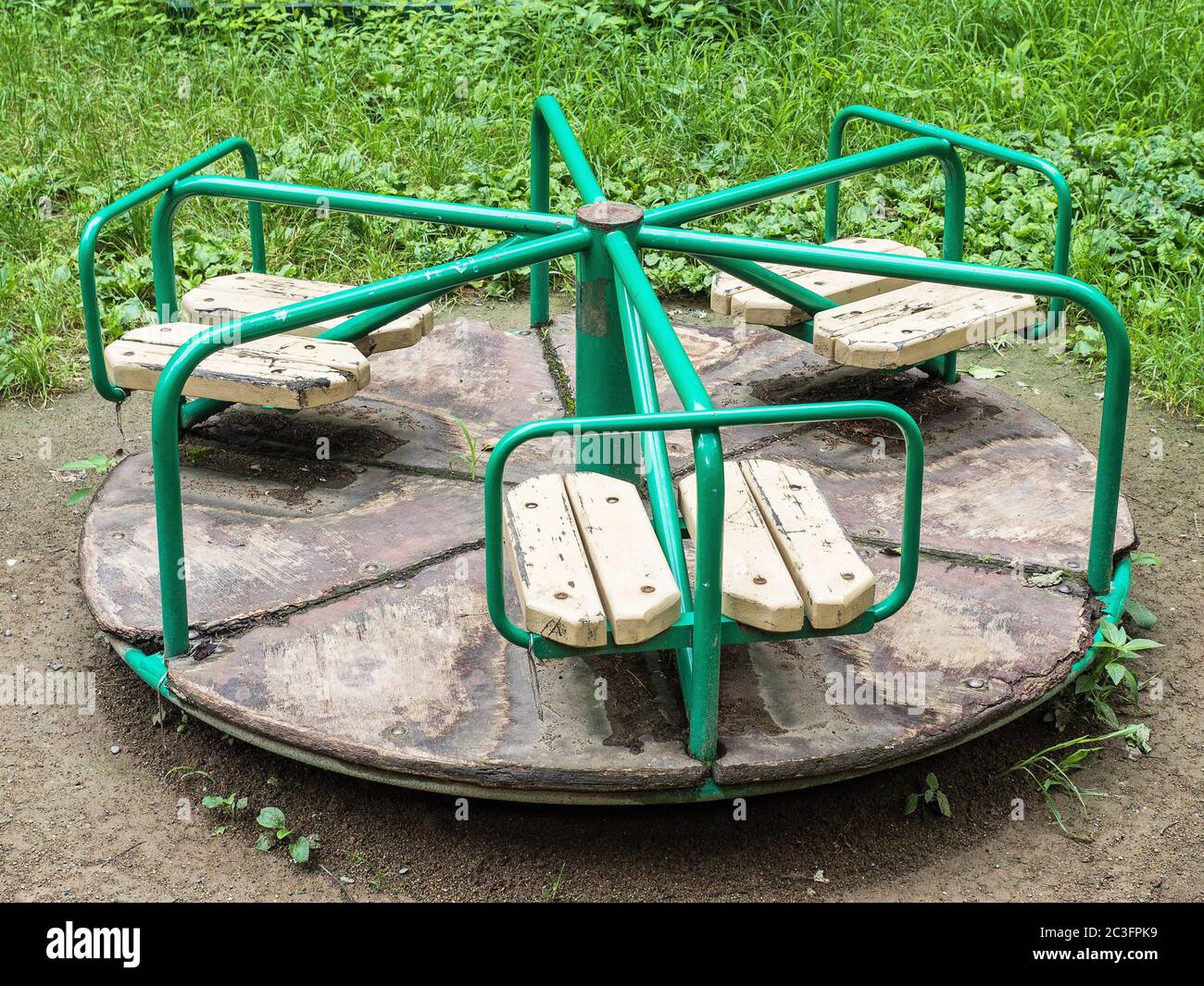 Round green swing in the playground on street Stock Photo - Alamy