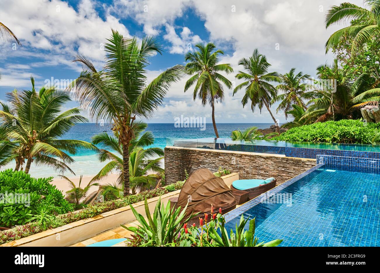 Beach with resort swimming pool at Seychelles Stock Photo - Alamy