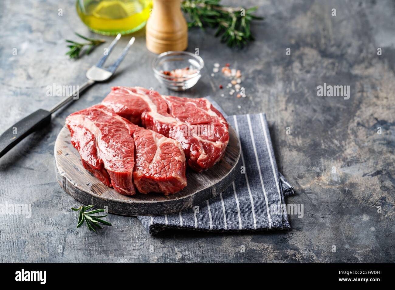 Raw beef steak on dark gray background Stock Photo - Alamy