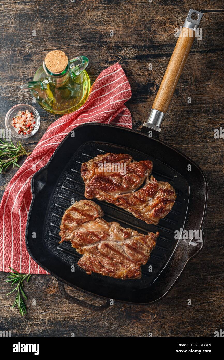 Two Beef steak in a grill pan Stock Photo - Alamy