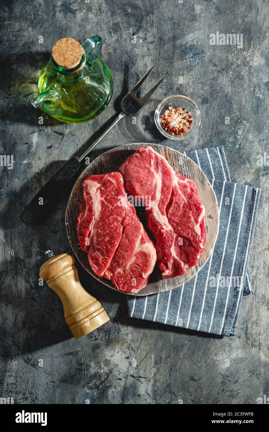 Raw beef steak on dark gray background Stock Photo - Alamy