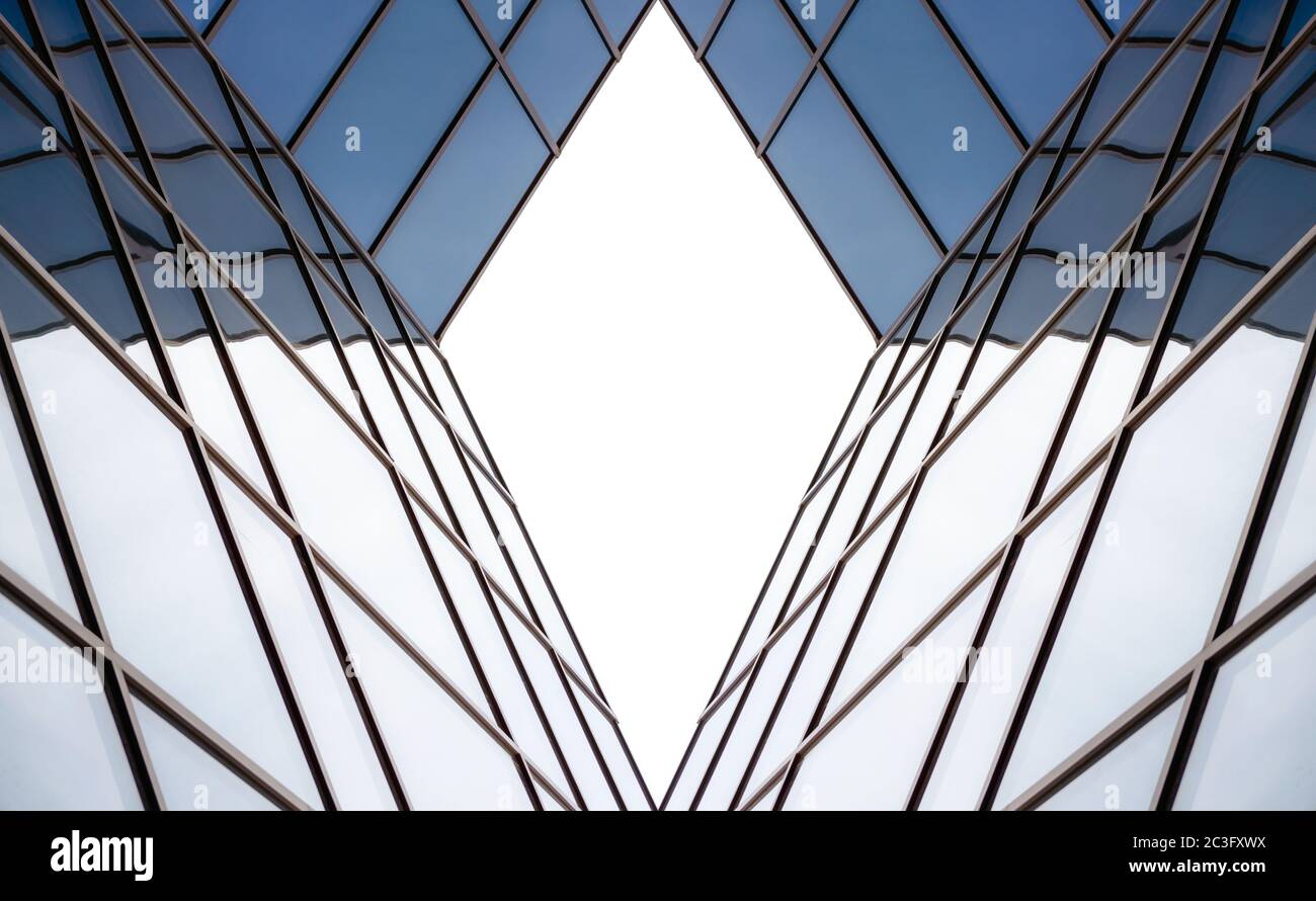 distorted reflections in the mirrored windows of a modern building ...