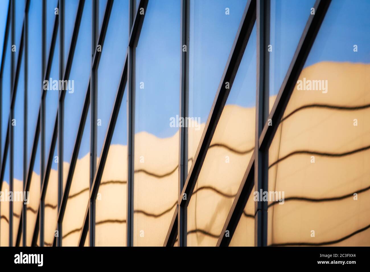 reflection with distortion in the window of a modern tall building ...