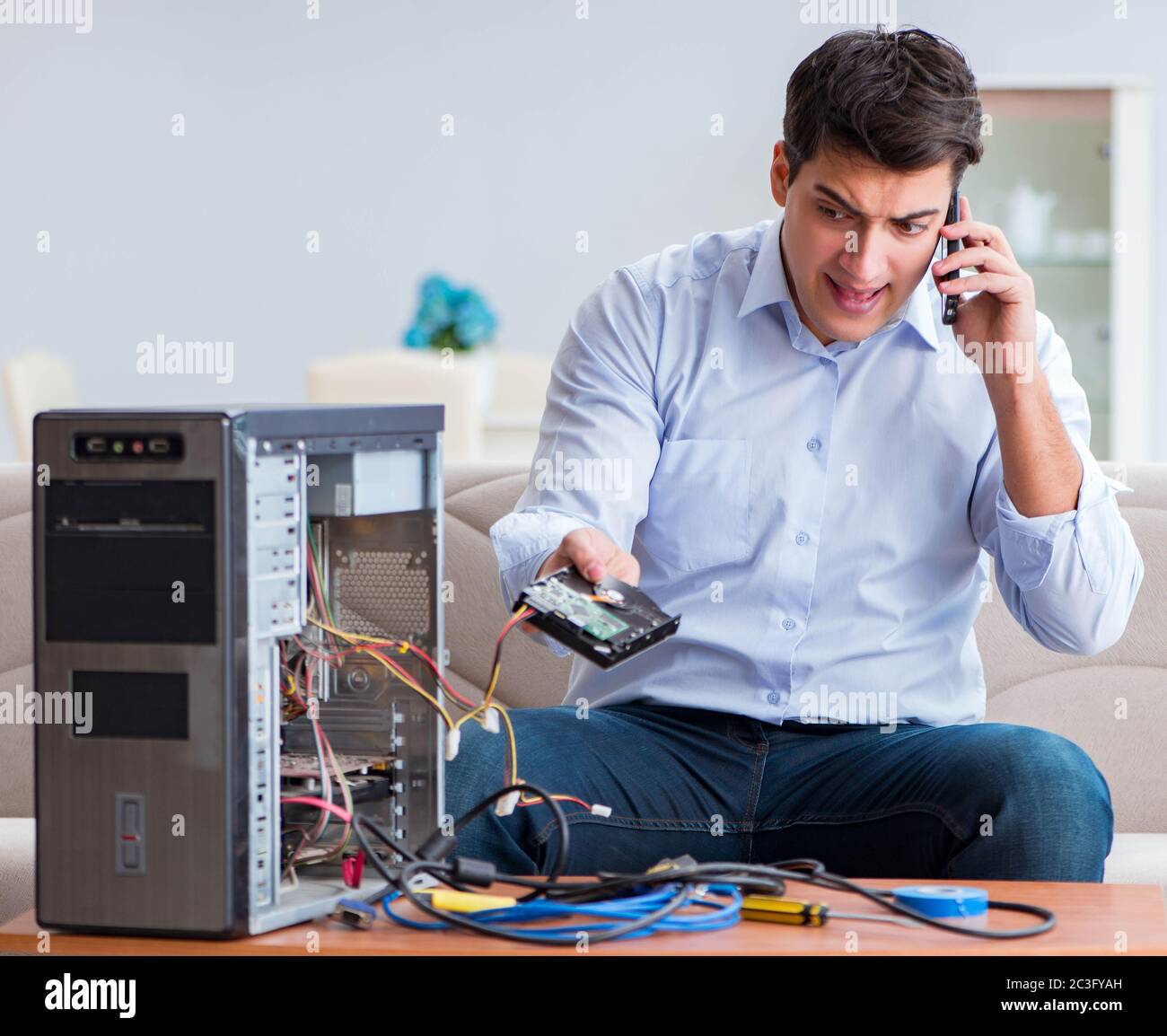 Angry customer trying to repair computer with phone support Stock Photo ...