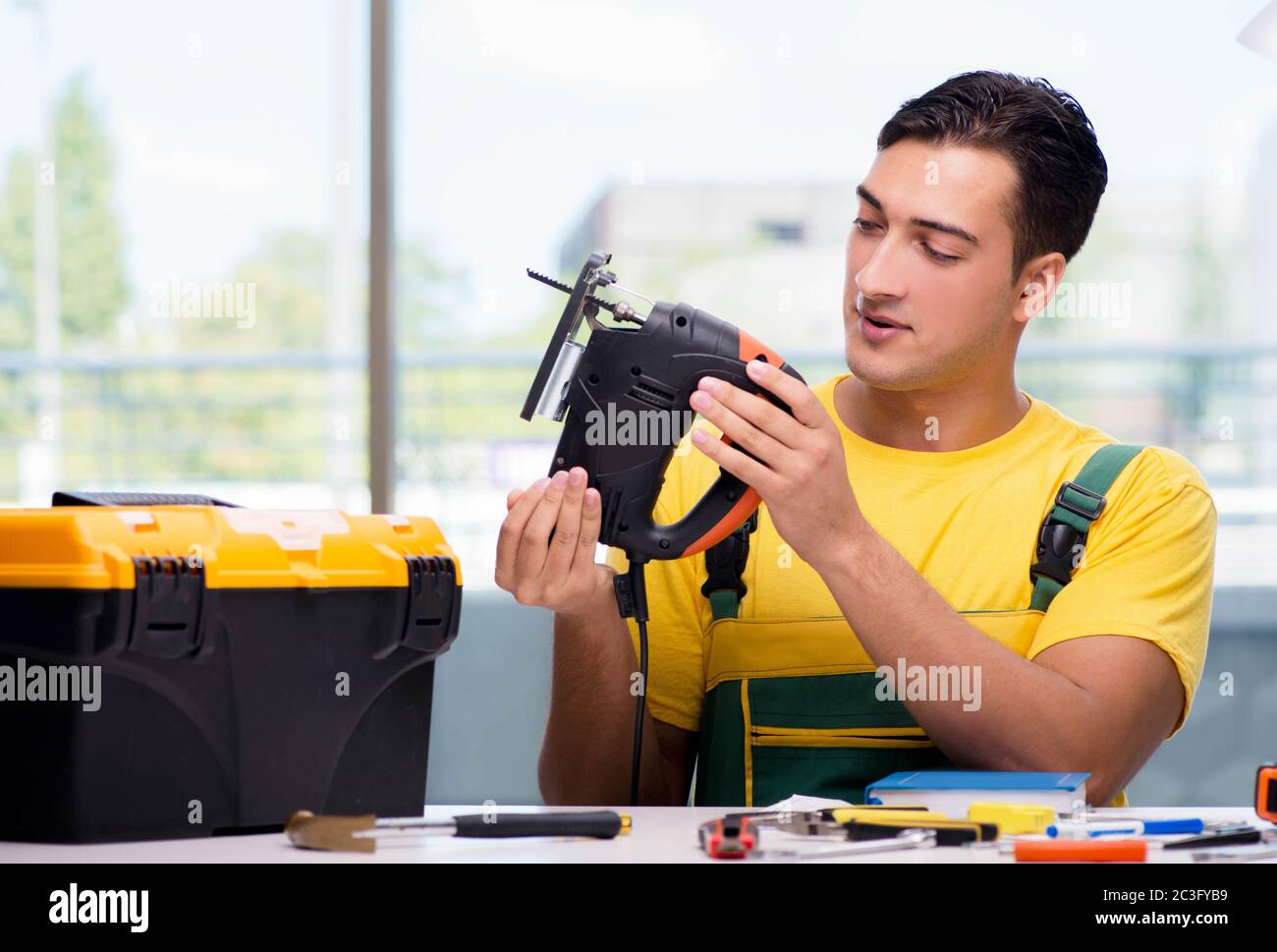Construction worker sitting at the desk Stock Photo - Alamy