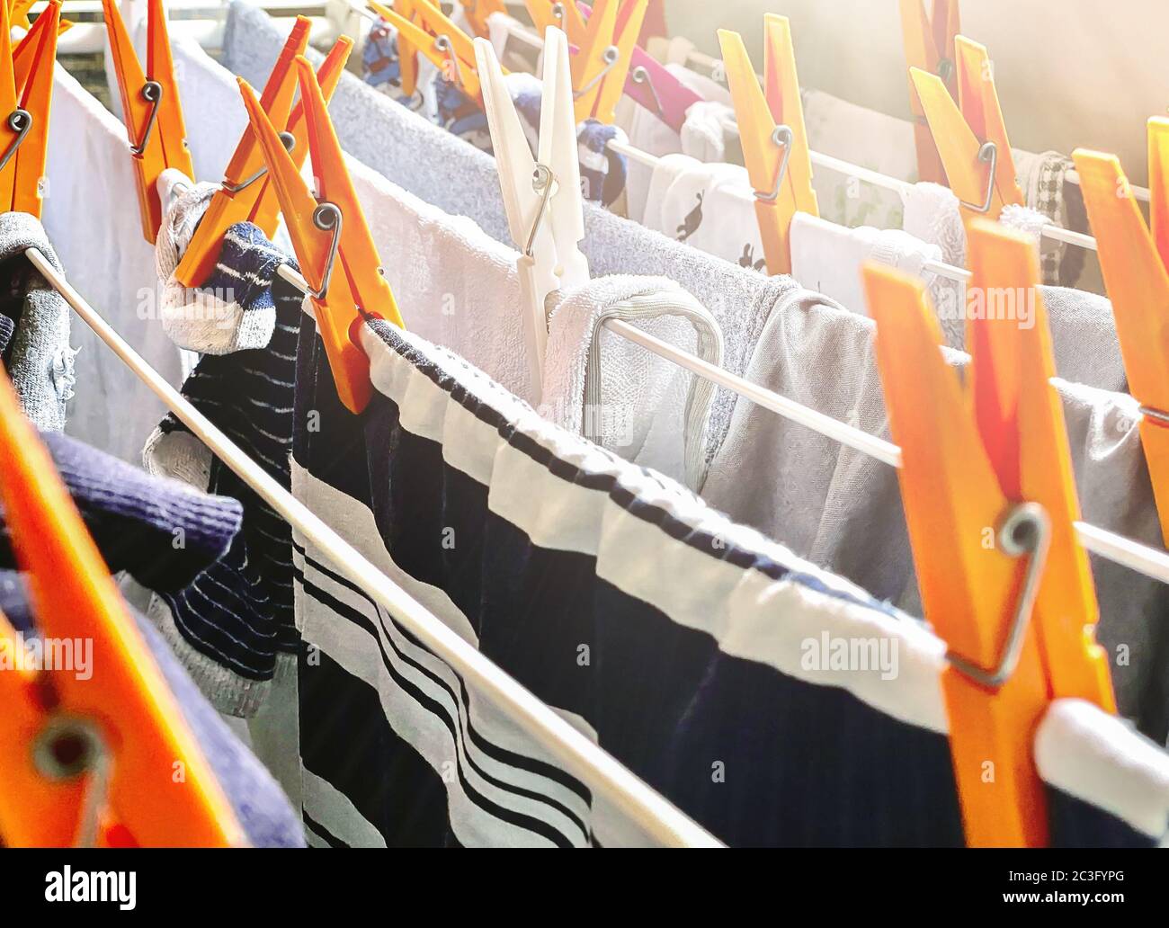a group of orange clothes pegs on a drying rack to dry the laundry ...