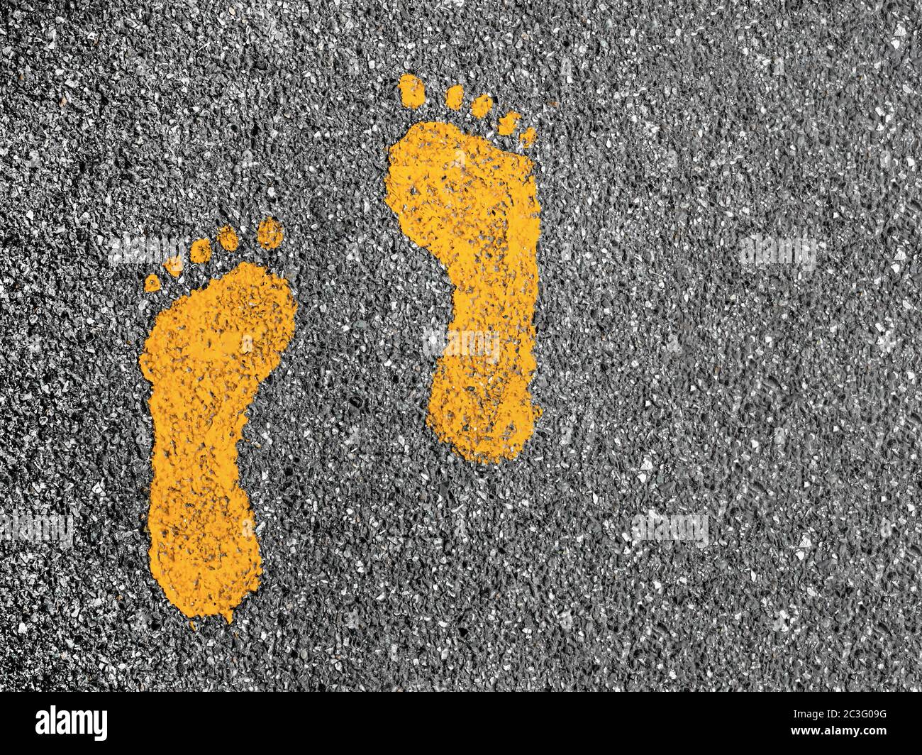 Orange footprints on asphalt Stock Photo - Alamy