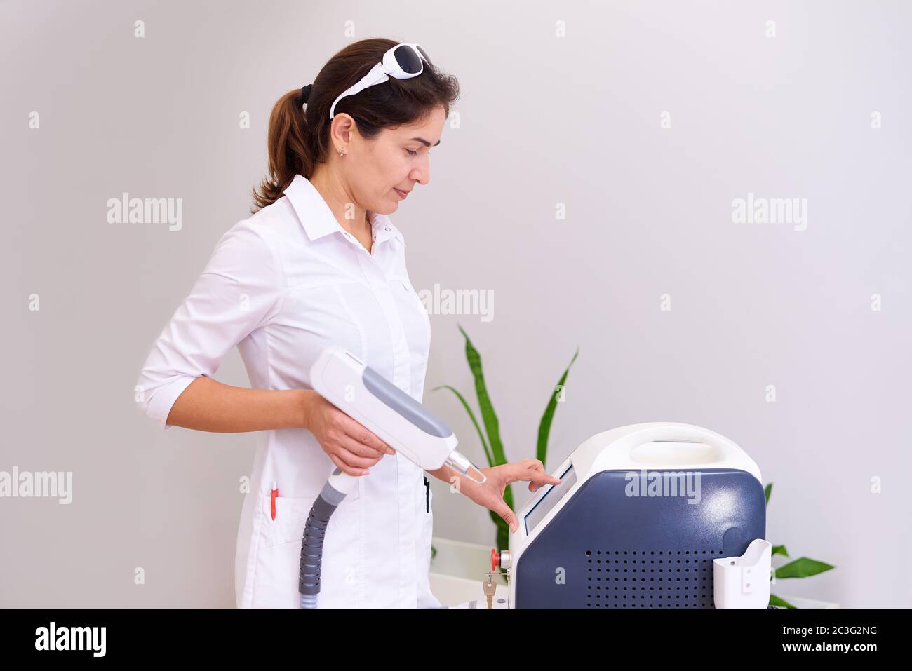 Doctor with apparatus for a laser procedure in a cosmetology clinic ...