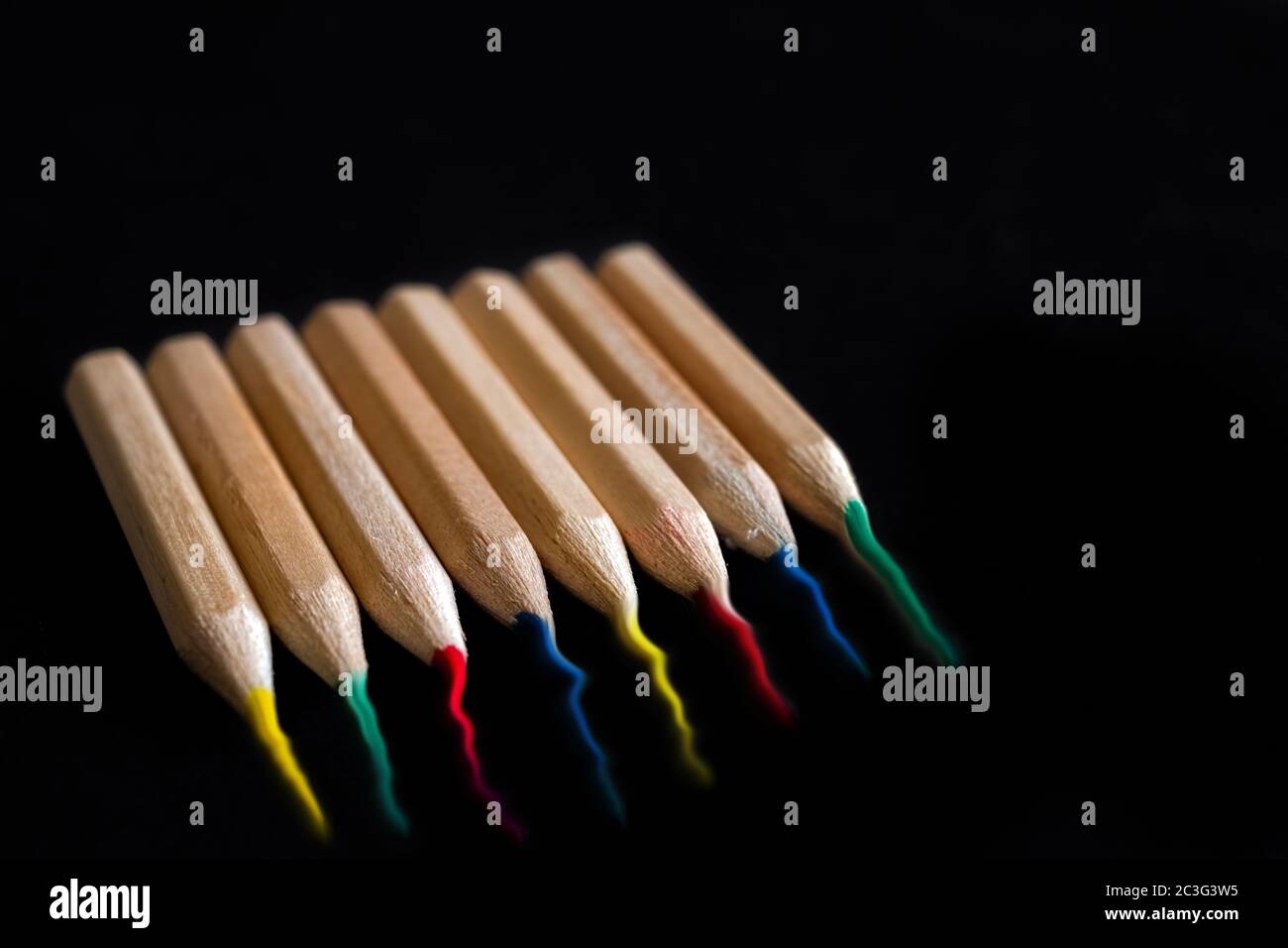 colored pencils on black background Stock Photo - Alamy