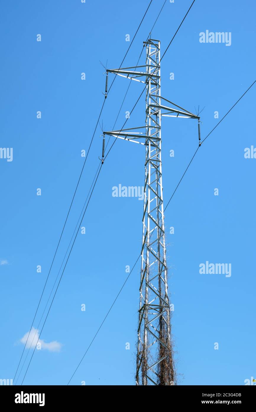 High voltage pole on blue sky Stock Photo - Alamy