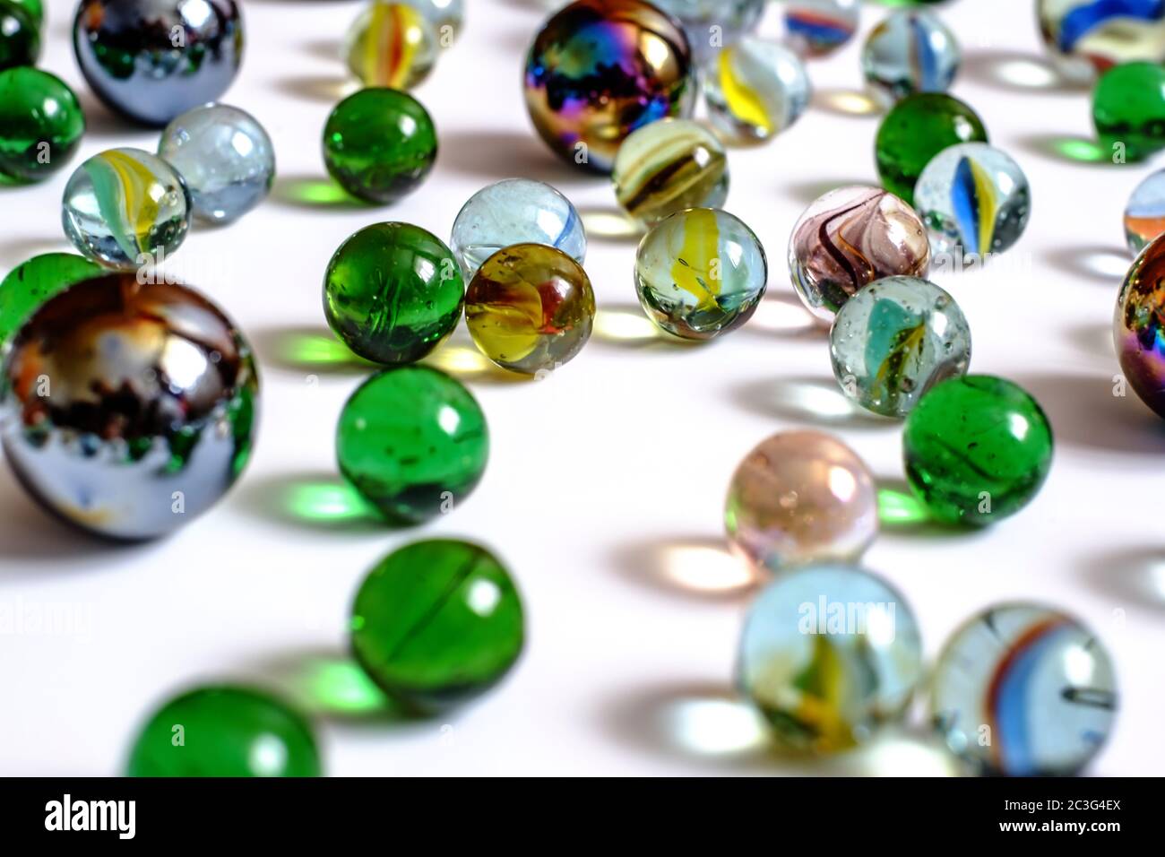 glass balls of various colors and sizes on white background Stock Photo ...