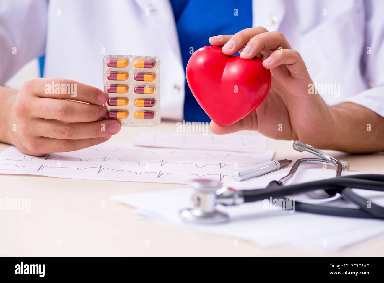 Male cardiologist examining pulse hi-res stock photography and images ...