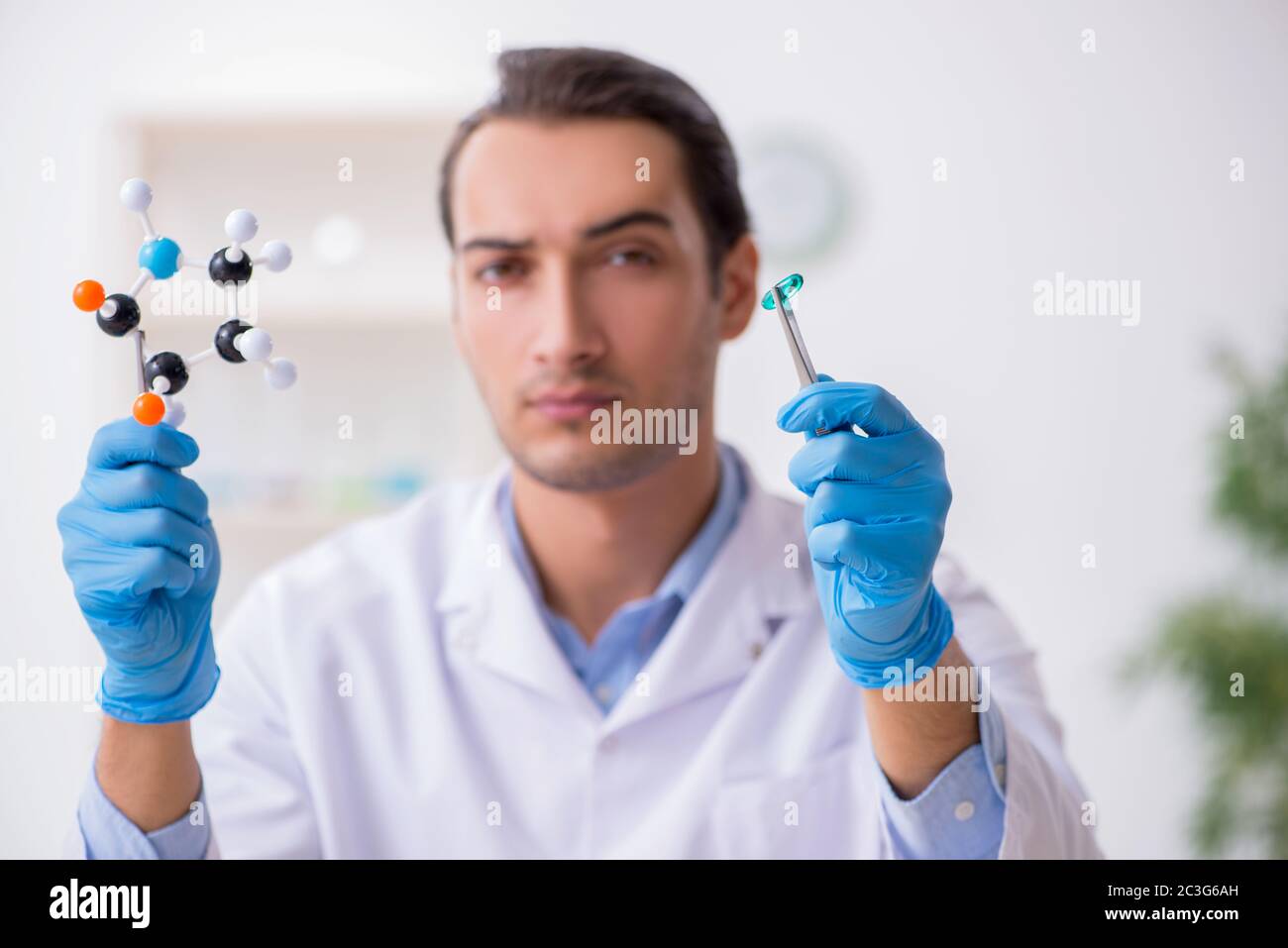 Young male lab assistant in drug synthesis concept Stock Photo - Alamy
