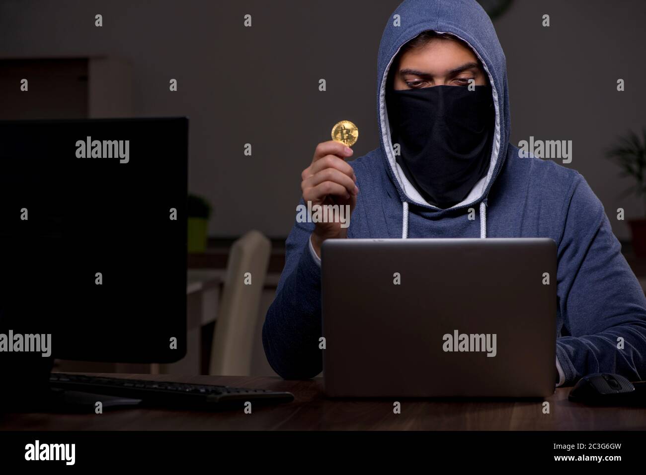 Male hacker hacking security firewall late in office Stock Photo - Alamy