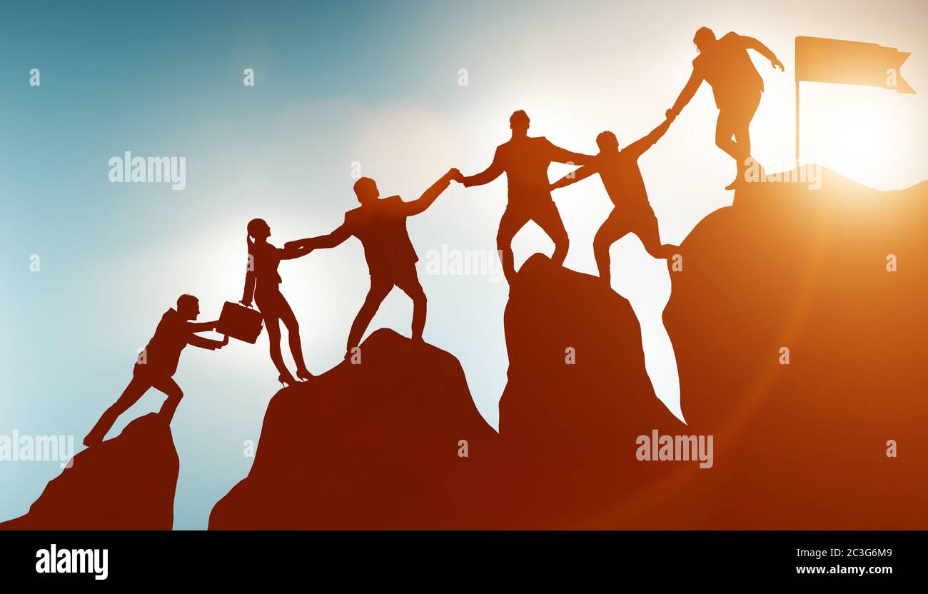 Concept of teamwork with team climbing mountain top Stock Photo - Alamy