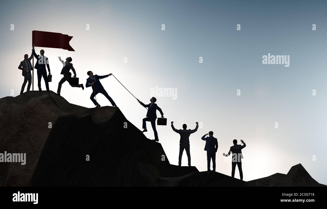 Concept of teamwork with team climbing mountain top Stock Photo - Alamy