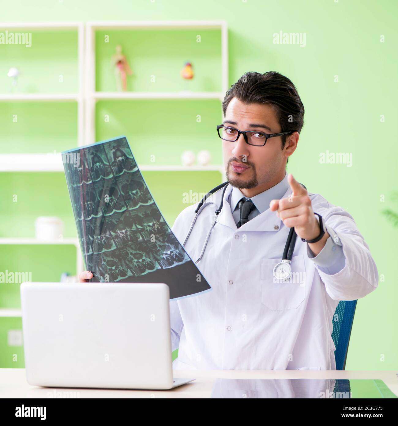 Doctor radiologist looking at x-ray scan in hospital Stock Photo - Alamy