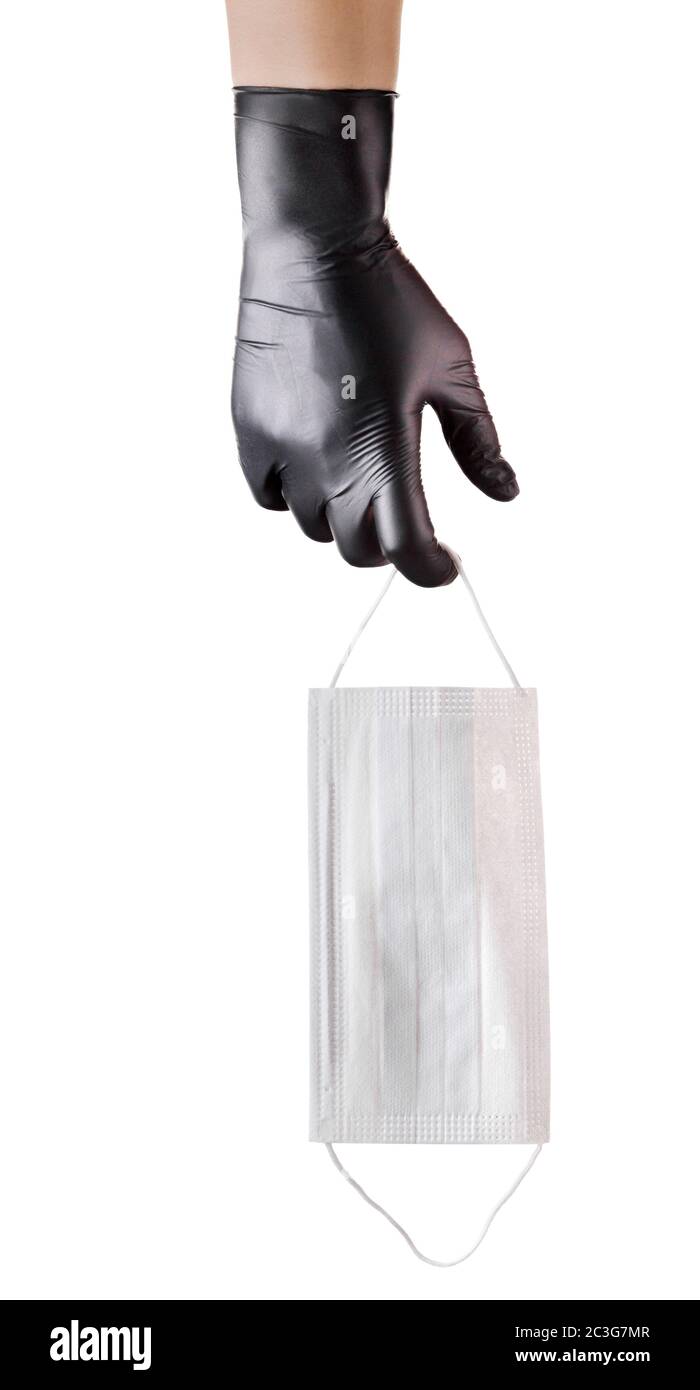 Hand in black gloves holding disposable face mask isolated on white ...